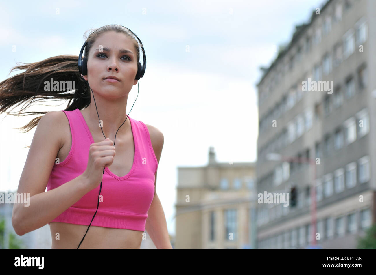 Woman running with headphones hi-res stock photography and images - Alamy