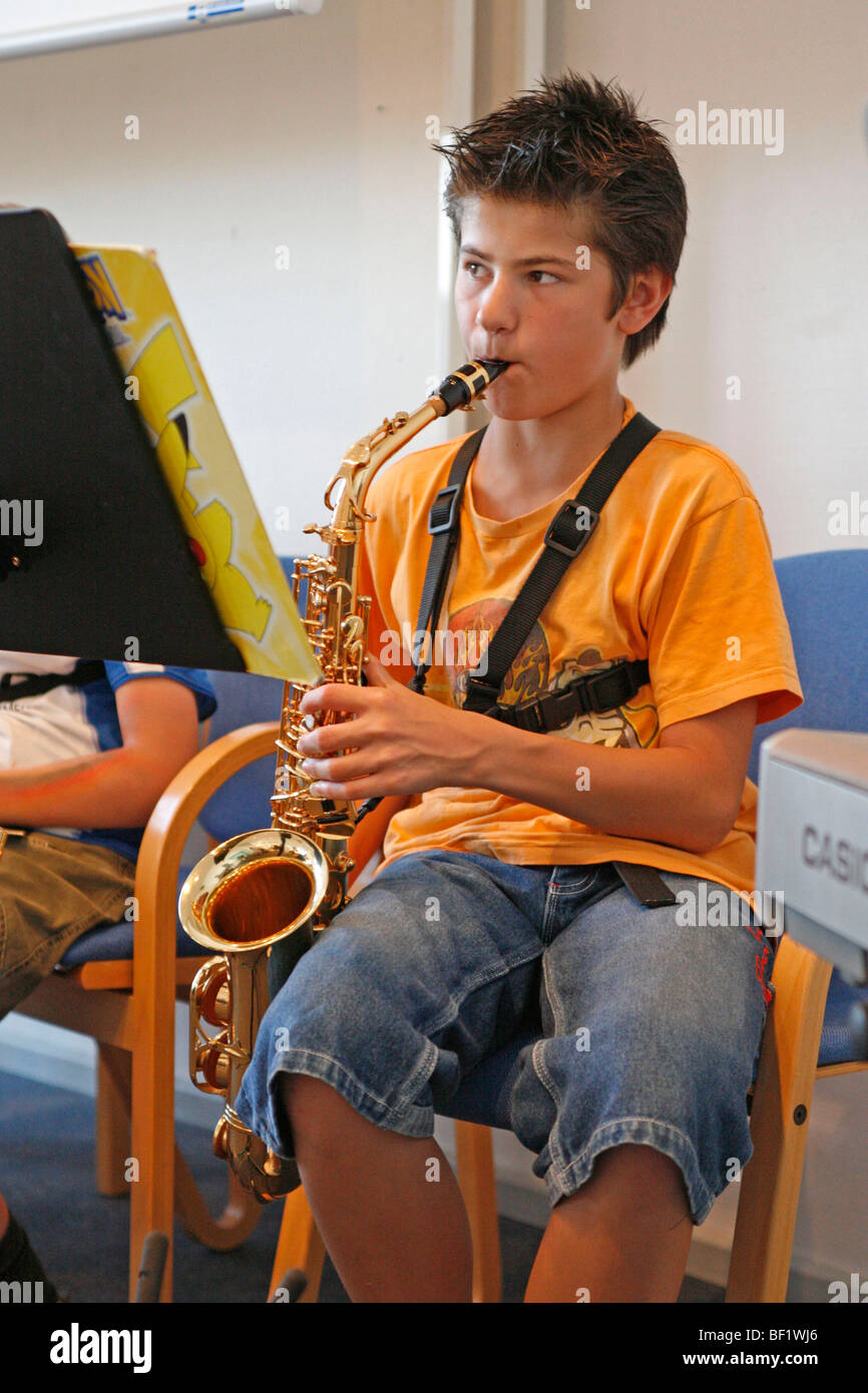 Boy playing saxophone hi-res stock photography and images - Alamy