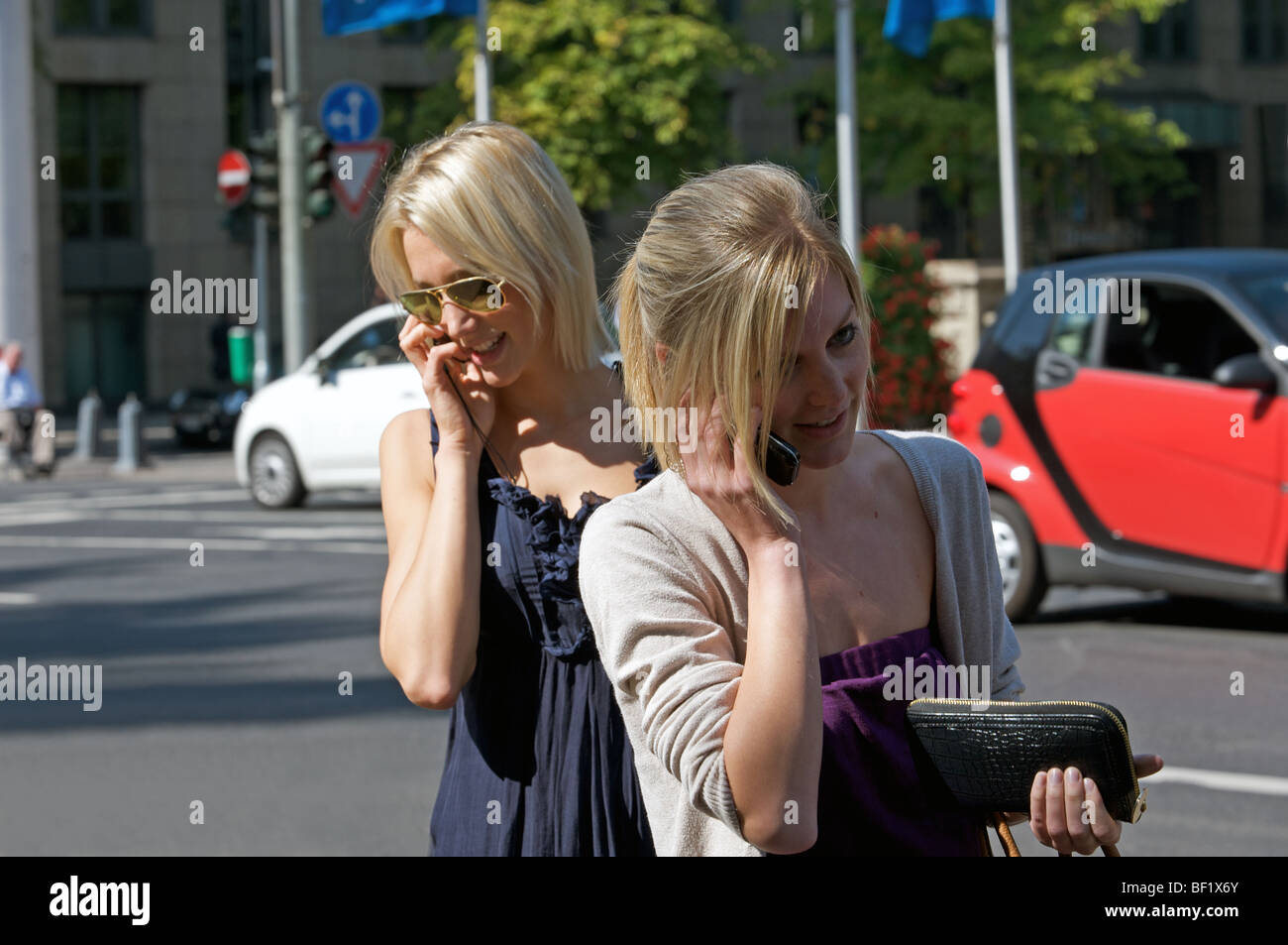 Teenage girls talking on mobile phones Stock Photo - Alamy