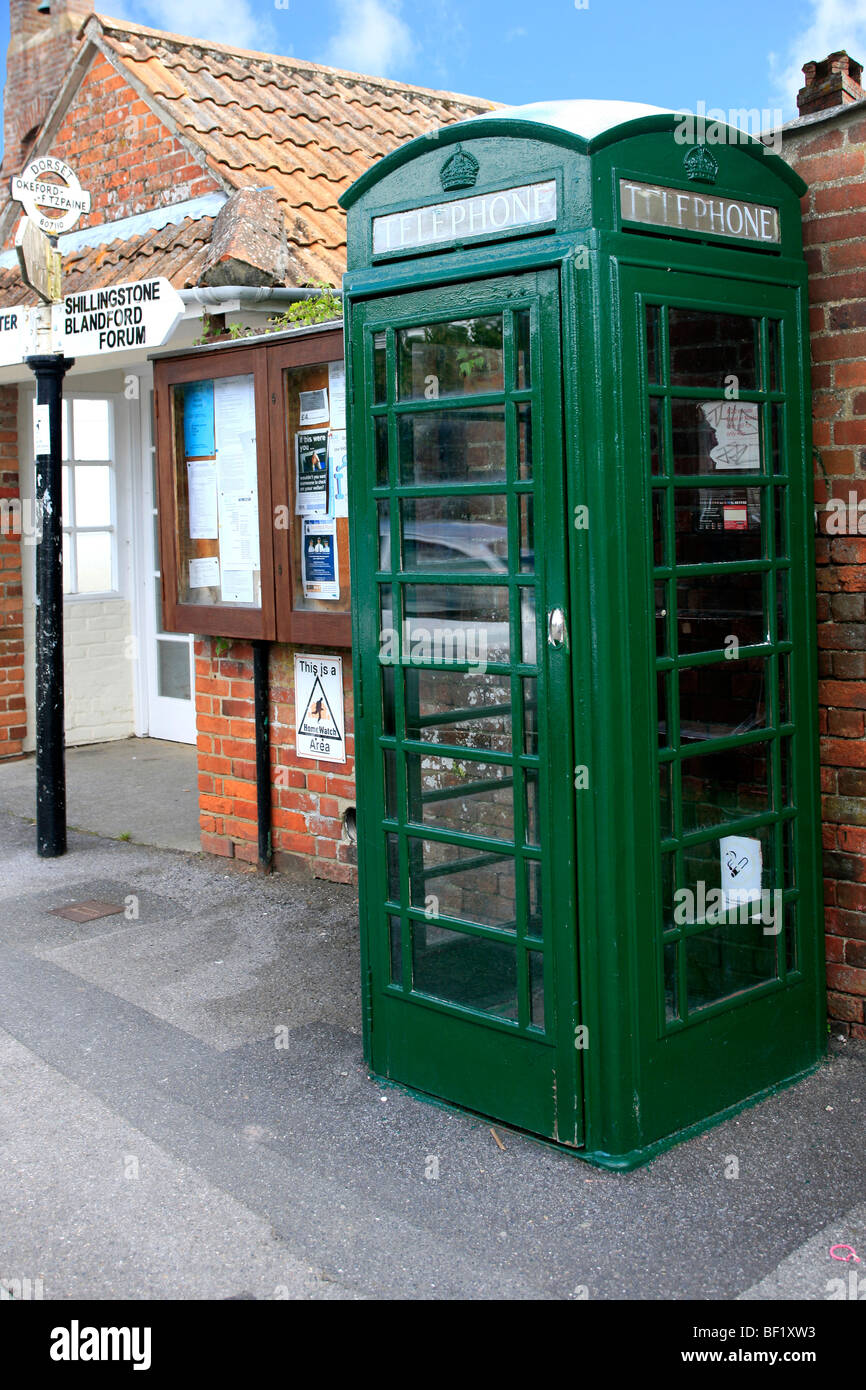 An old fashioned English telephone box painted green Stock Photo - Alamy