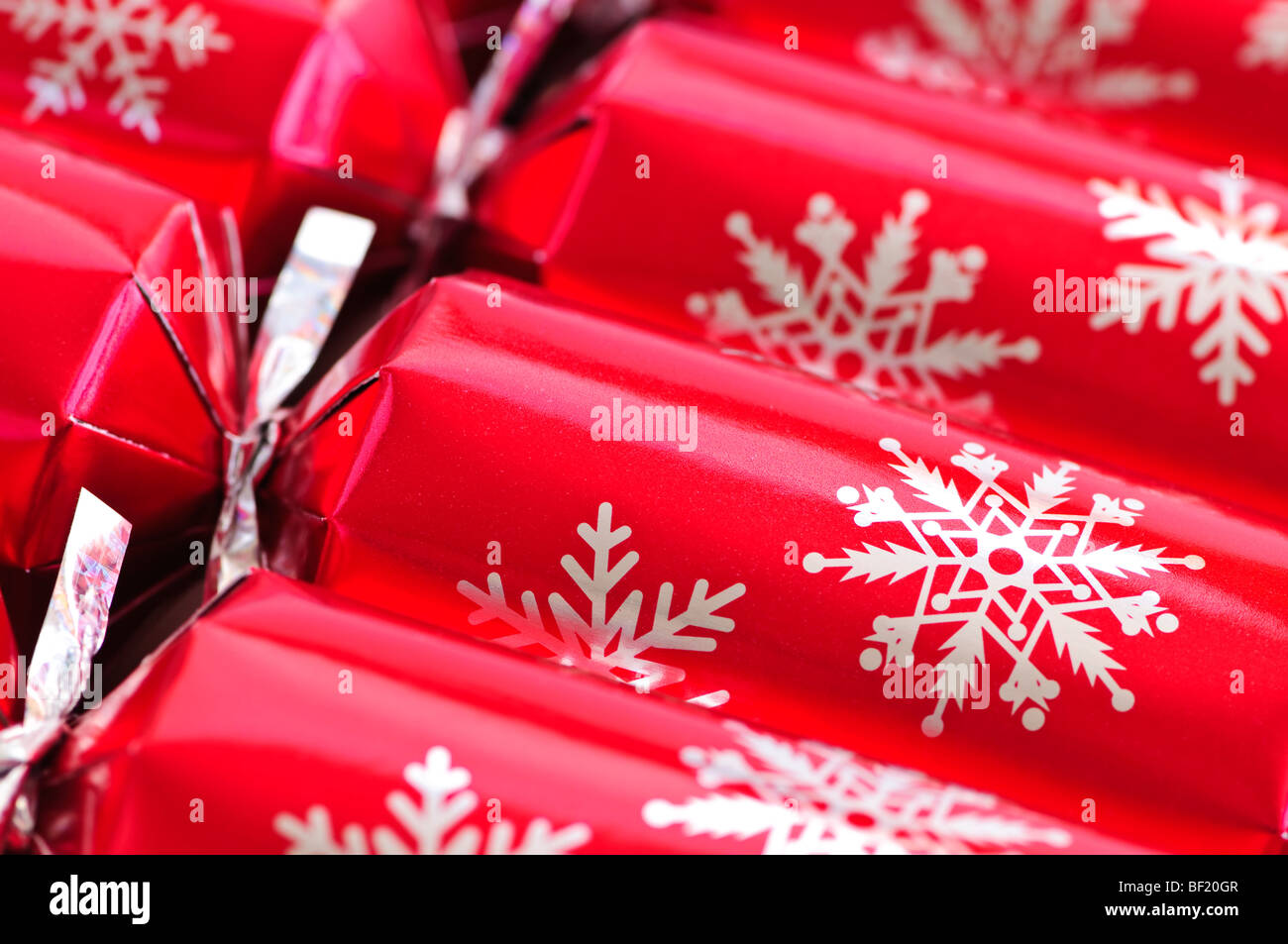 Closeup of many red Christmas crackers in a row Stock Photo - Alamy