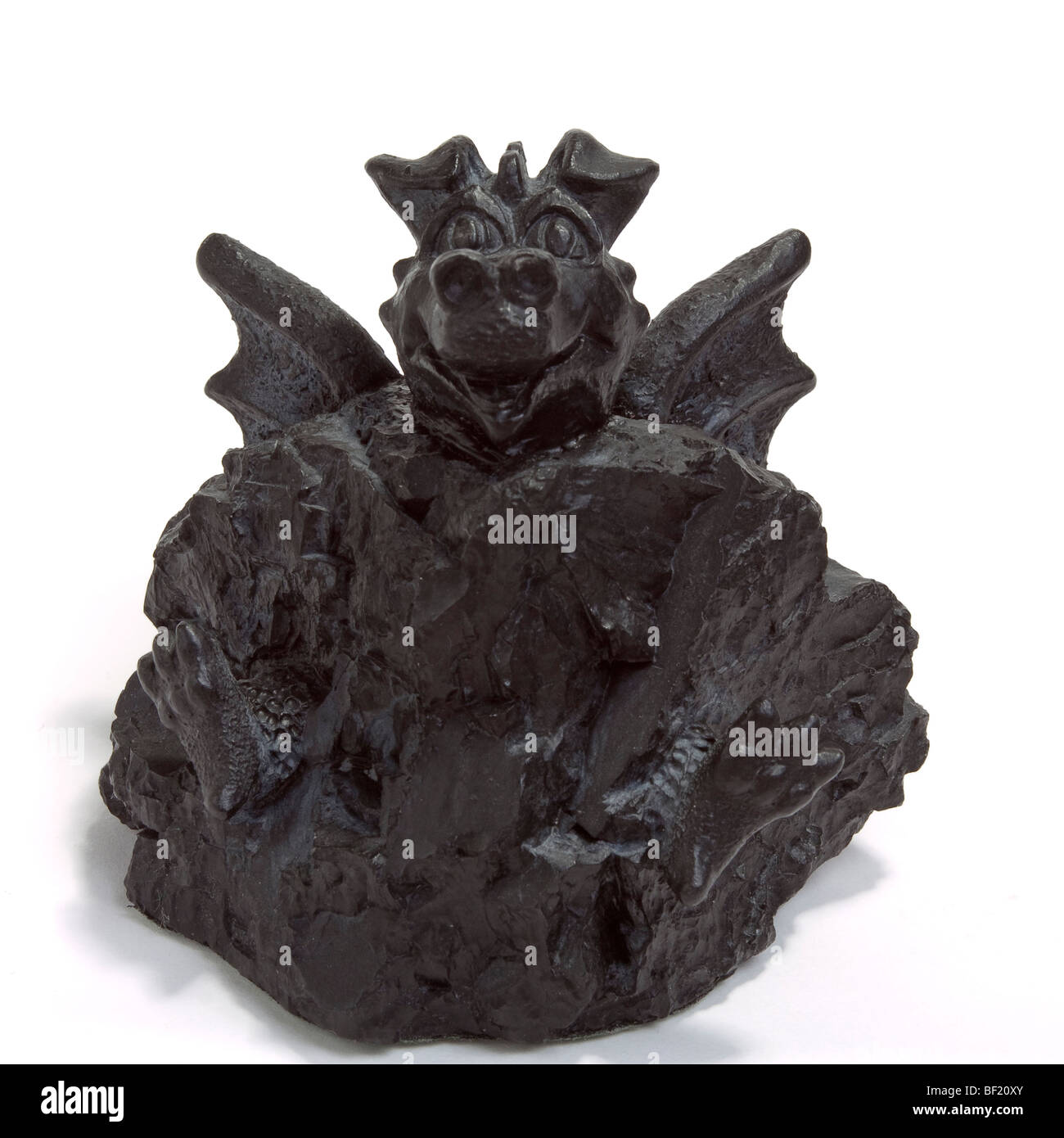 Cheeky welsh dragon carved from coal isolated against white background ...