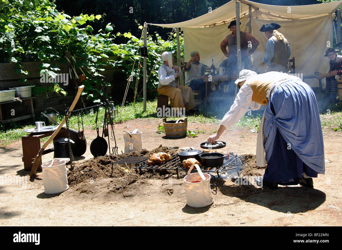 Woman cooking in military tent camp - costumed American Revolutionary ...