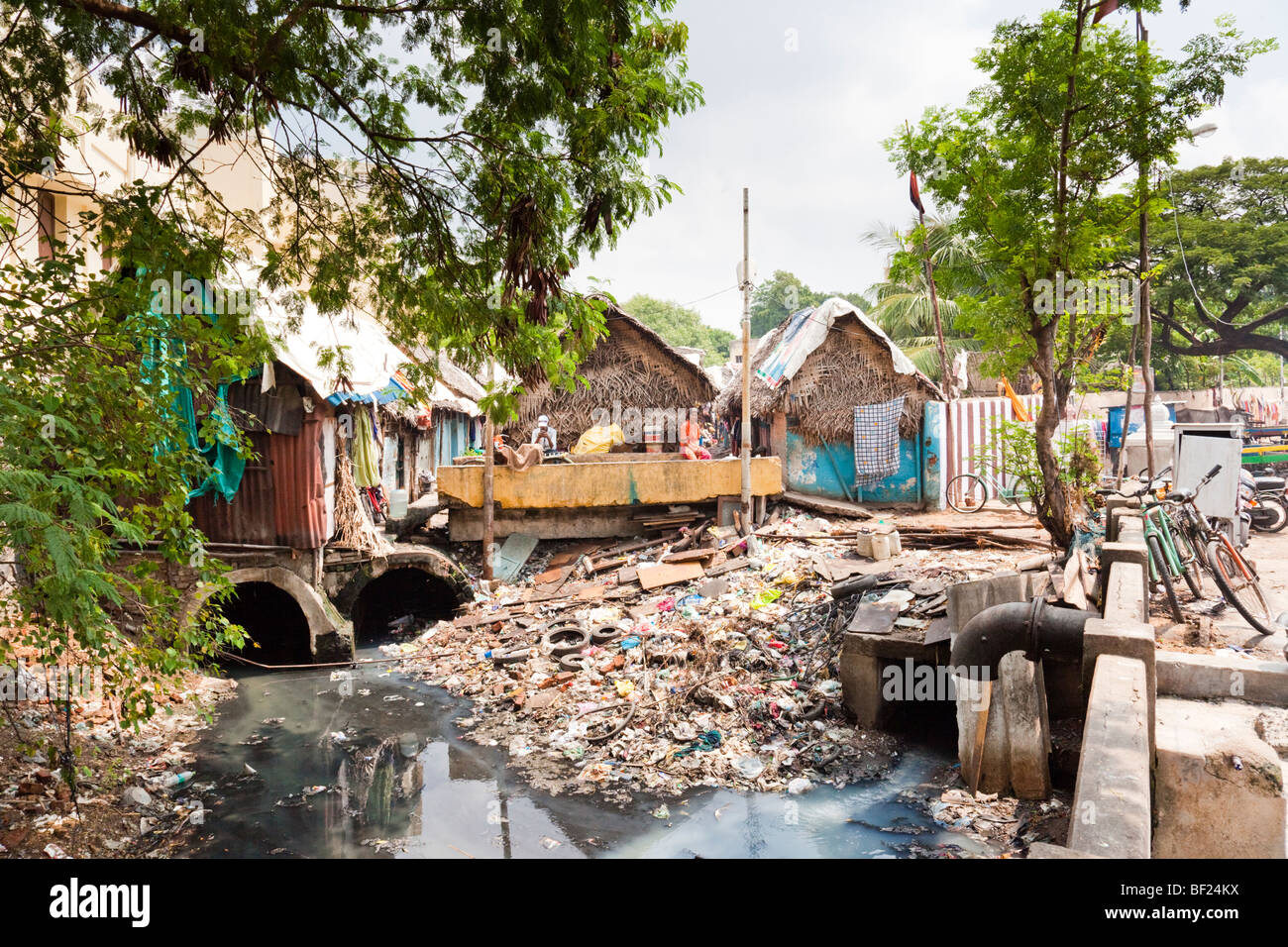 Shanty town next to a heavily polluted river and trash. Chennai Tamil ...
