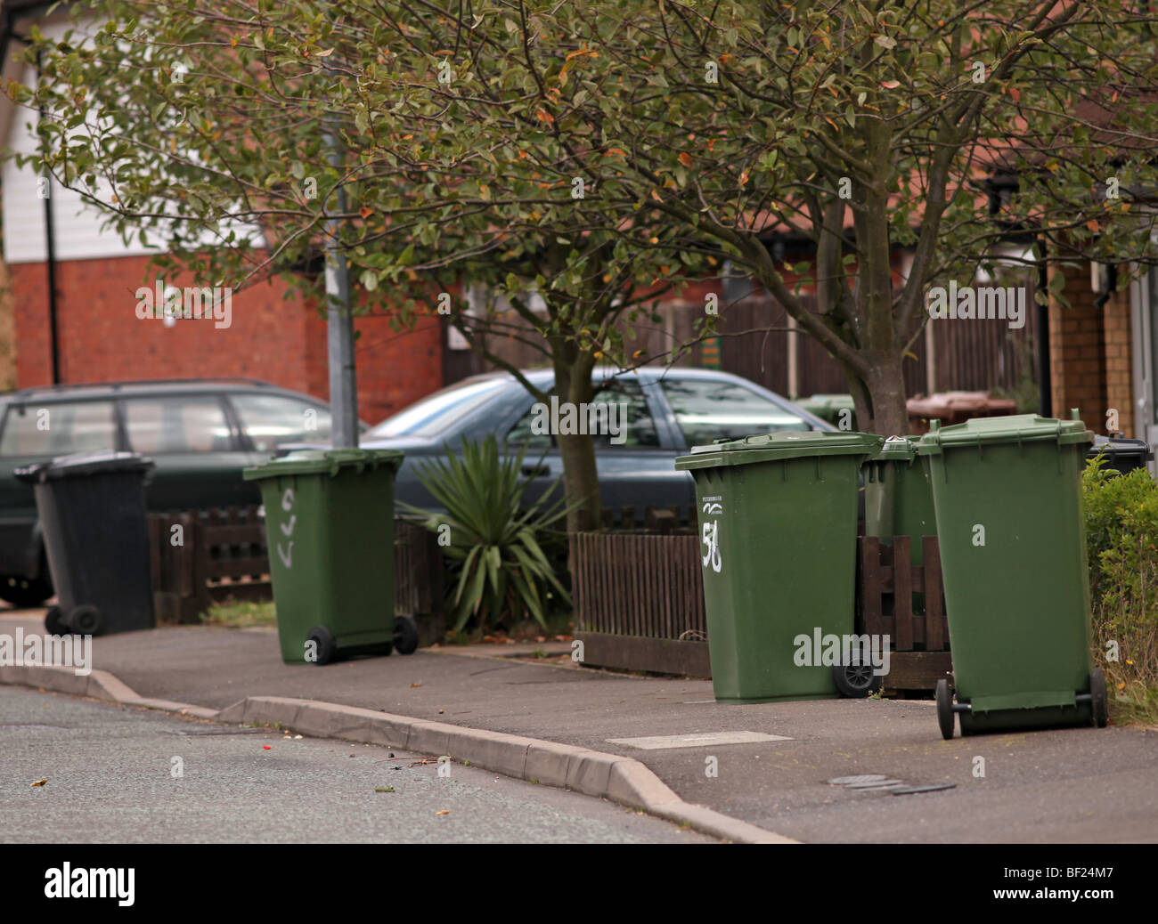 Green recycling dustbins in Peterborough Stock Photo - Alamy