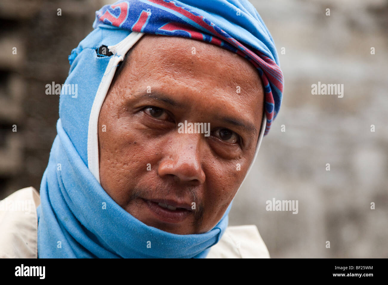 Portrait of a Filipino man wearing a headscarf made from a t-shirt ...