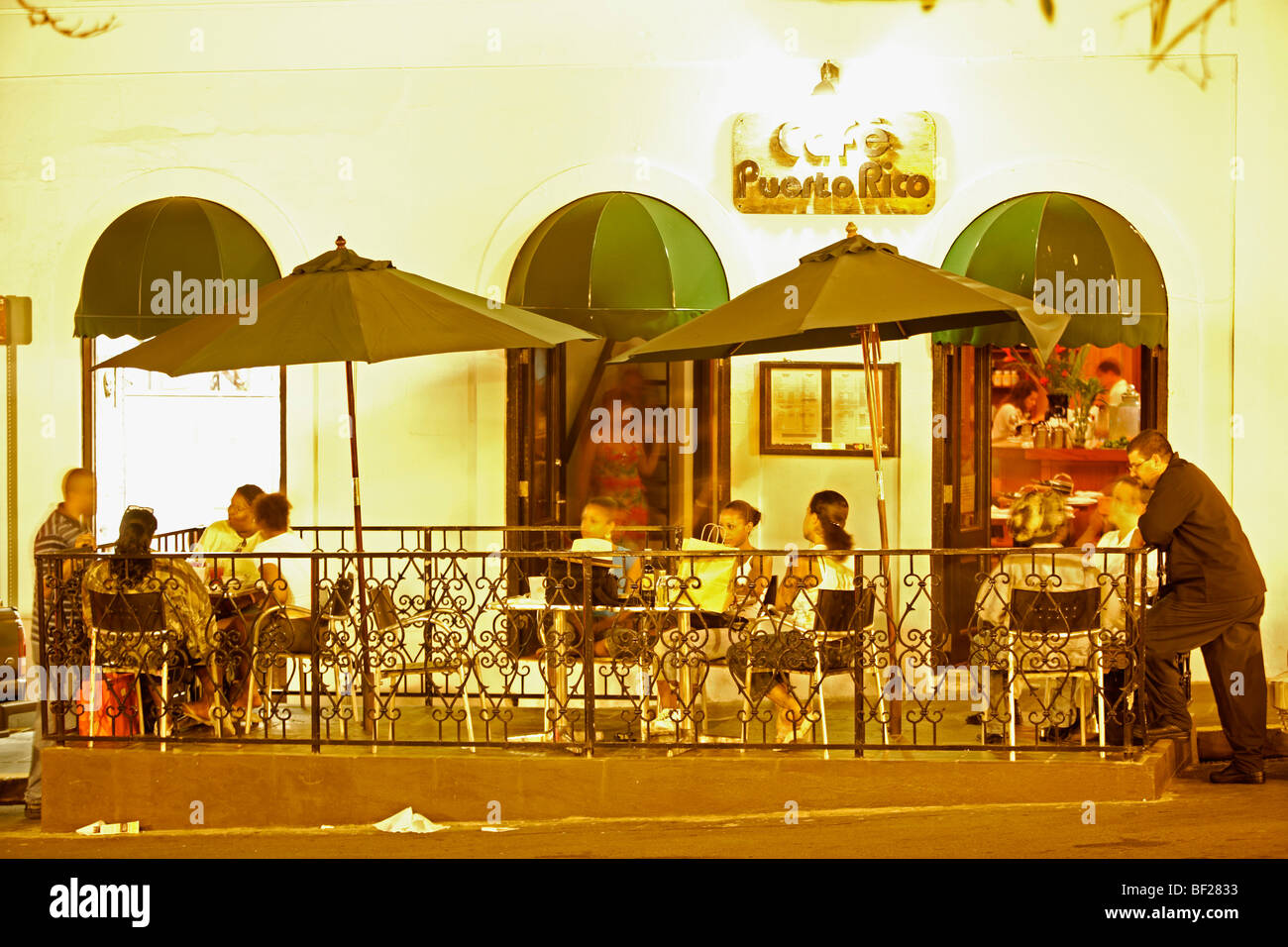 People at the terrace of Cafe Puerto Rico at night, San Juan, Puerto ...