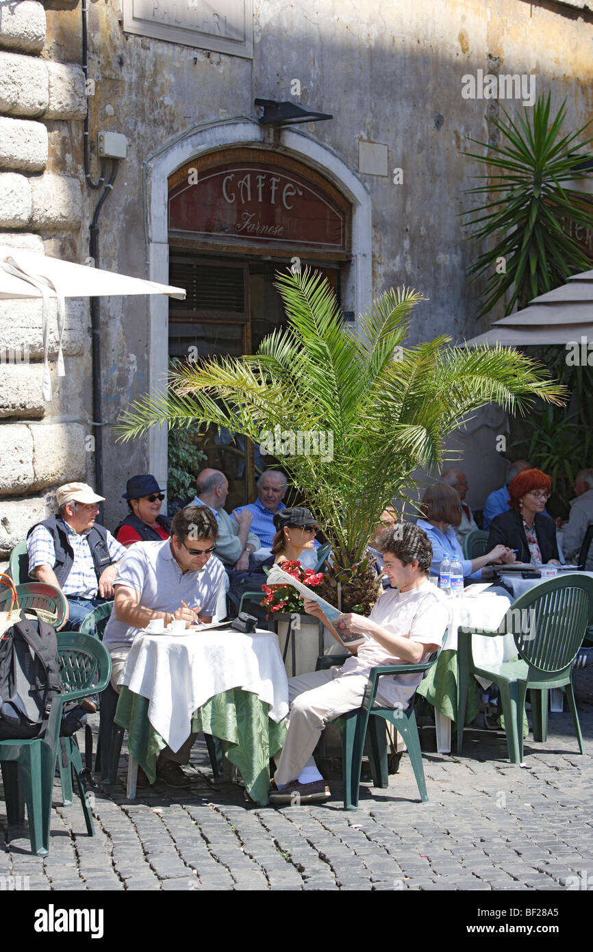 People sitting in front of Cafe Farnese in the sunlight, Piazza Farnese ...