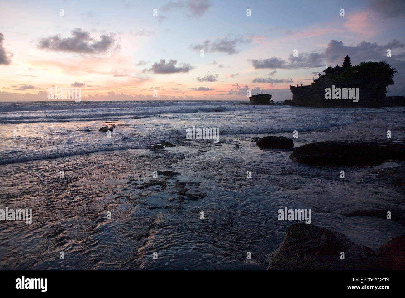 Sunset at Hindu Temple Pura Tanah Lot on the southwestern coast of Bali ...