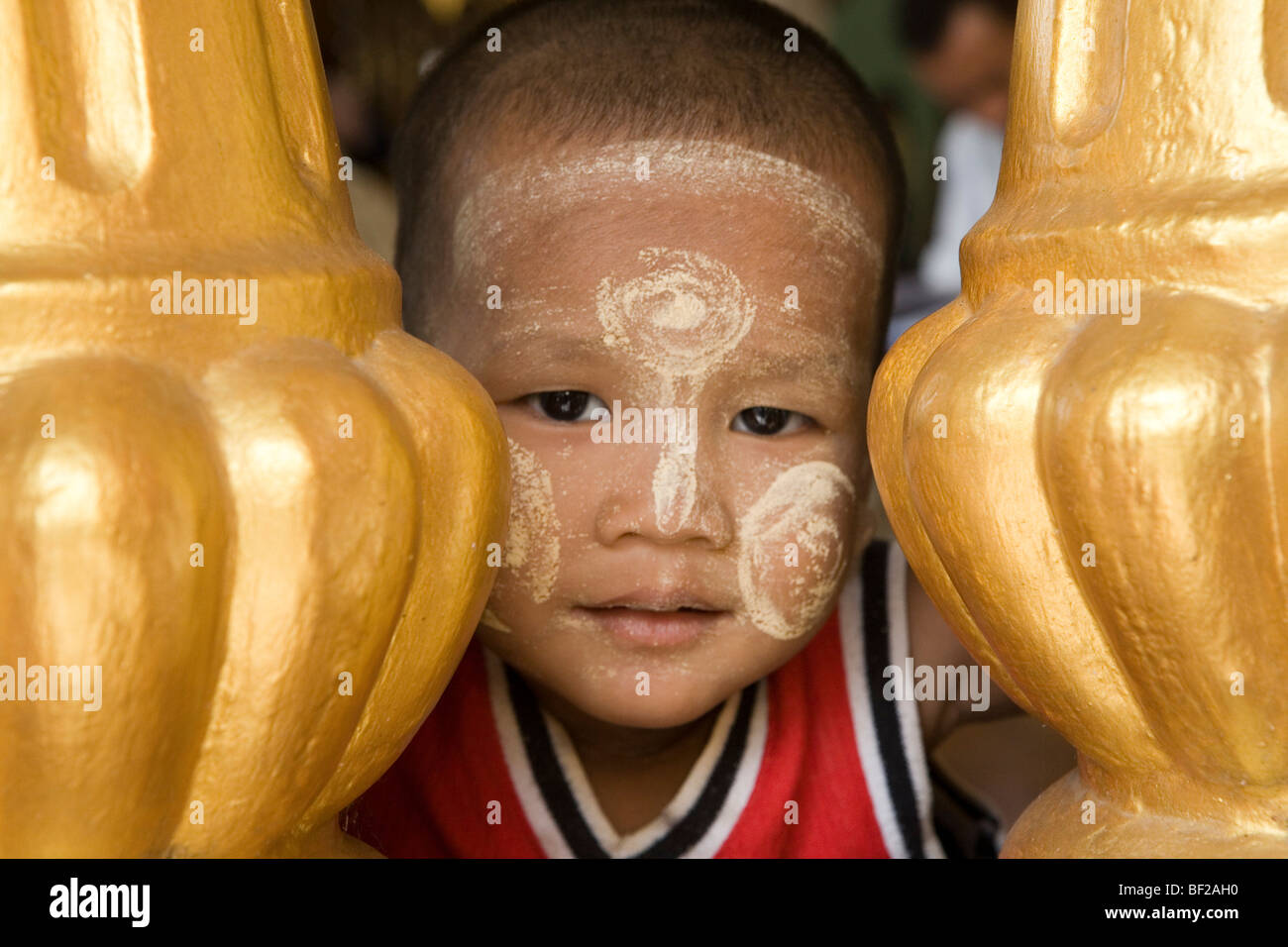 Face of a young burmese boy on the grounds of the Shwedagon Pagoda at ...