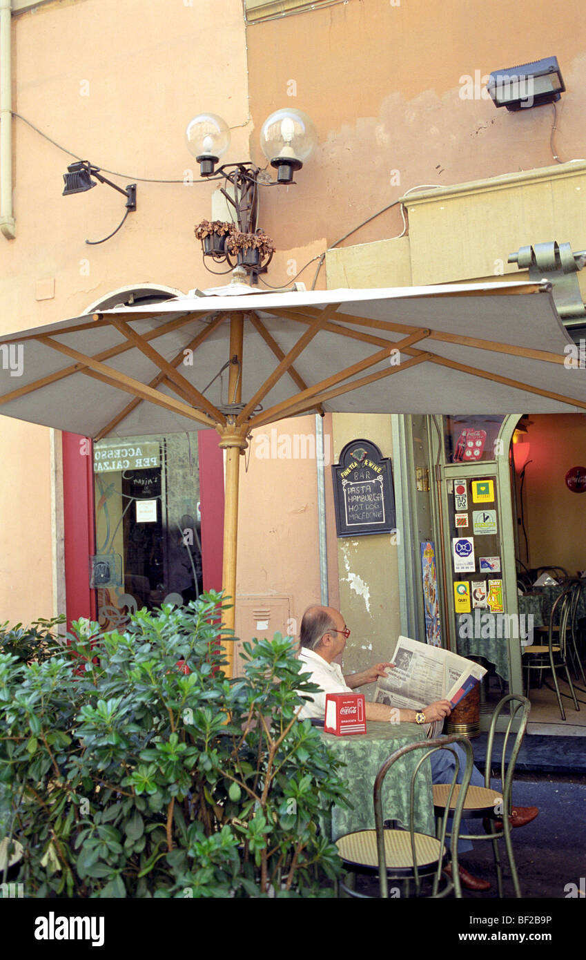 Senior reading newspaper in cafe, Rome, Italy Stock Photo - Alamy