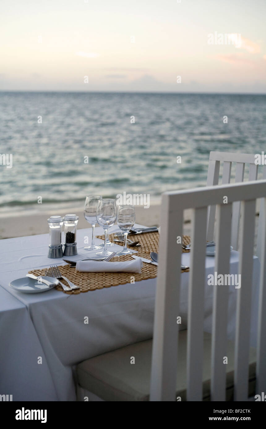 Romantic table setting for two on tropical island beach, Seychelles ...
