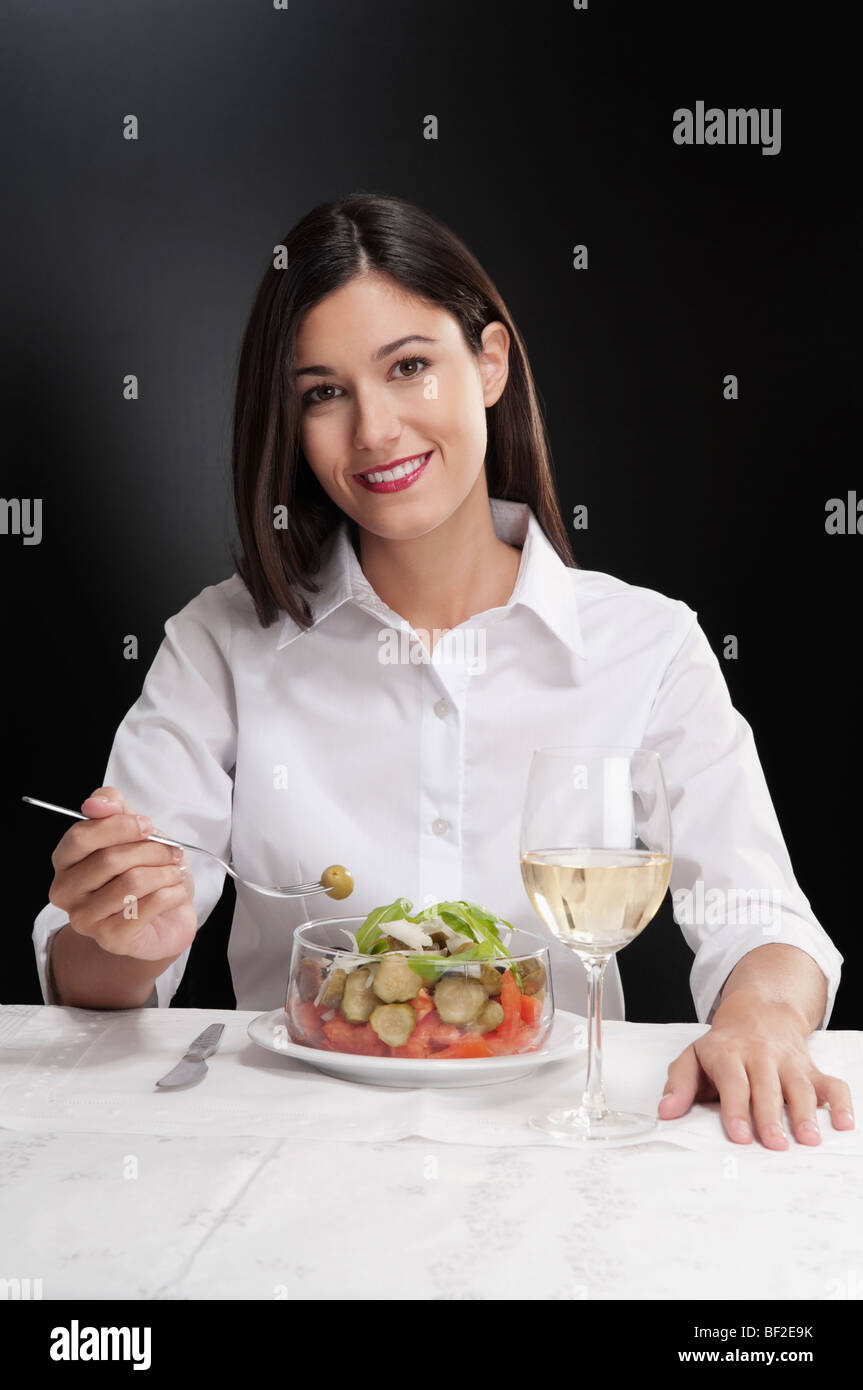 Woman eating salad and smiling Stock Photo - Alamy