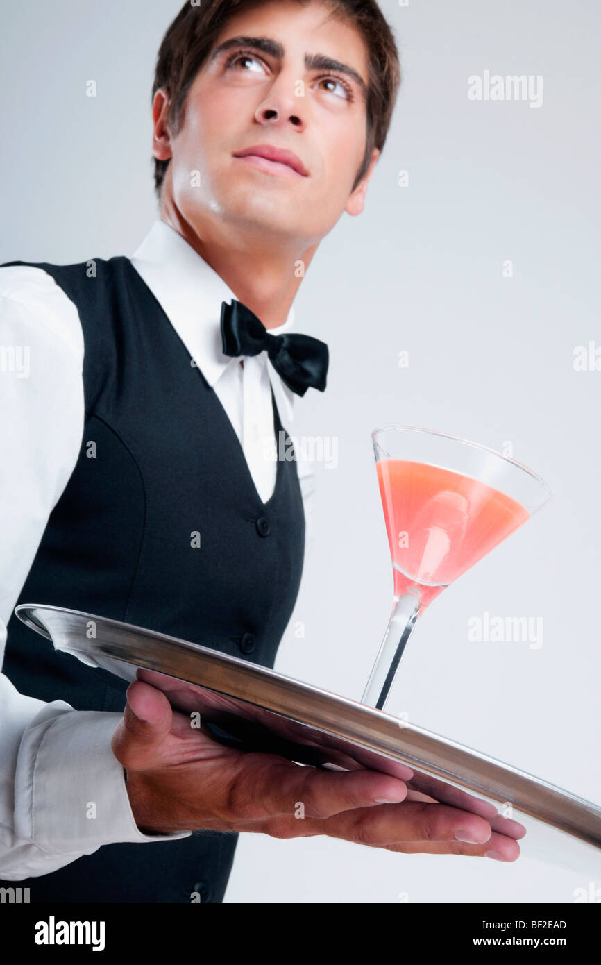 Close-up of a waiter holding a cocktail on a tray Stock Photo - Alamy