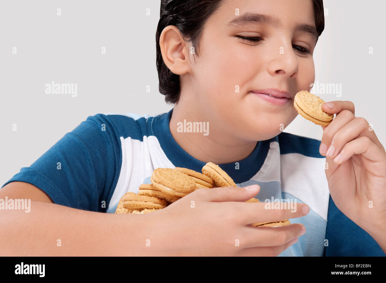 Close-up of a boy eating a cookie Stock Photo - Alamy