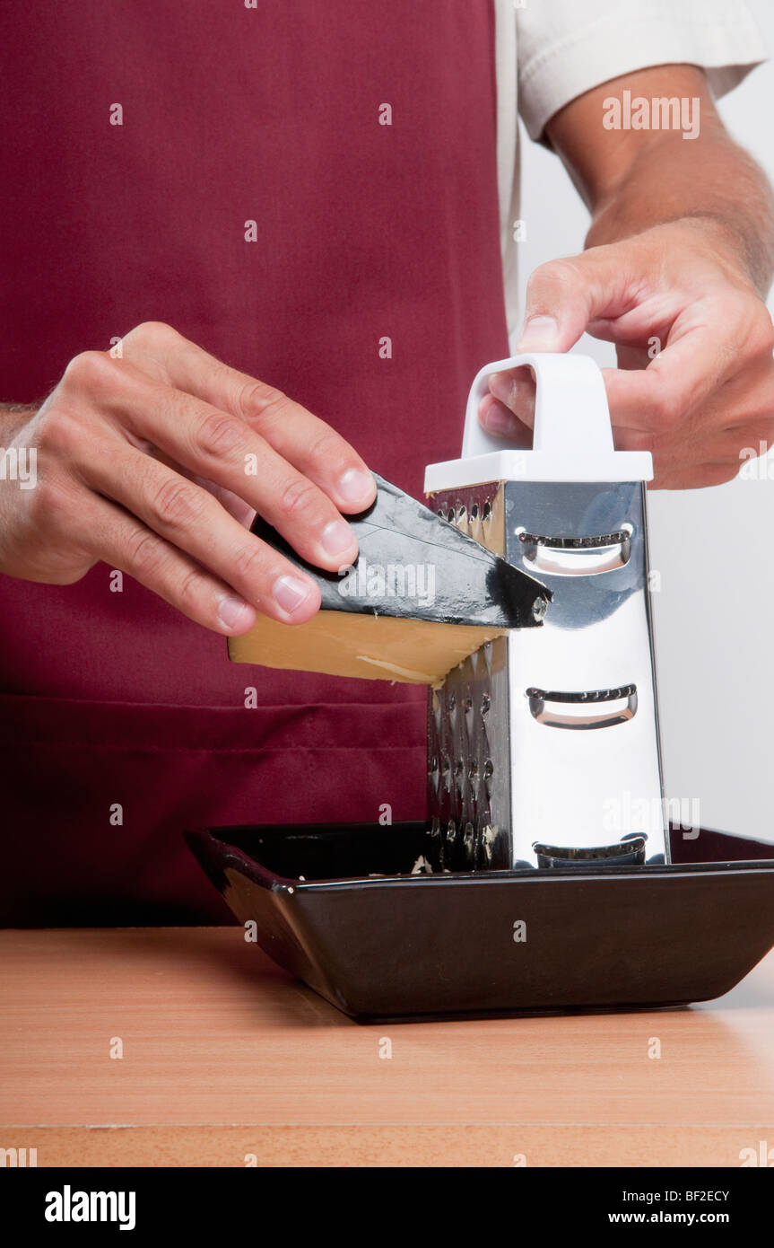 Mid section view of a man grating cheese Stock Photo - Alamy