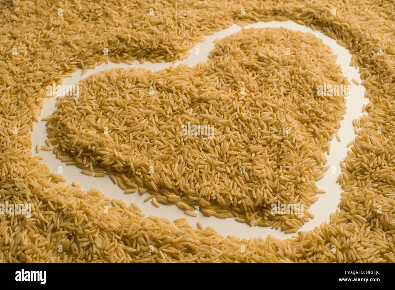 Heart shape drawn on brown rice Stock Photo - Alamy