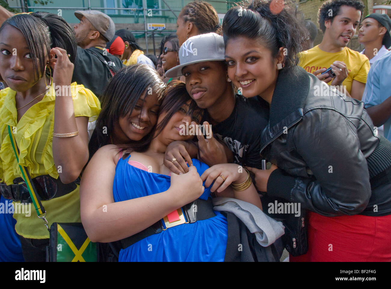 Group of young people messing around and posing in back streets of ...