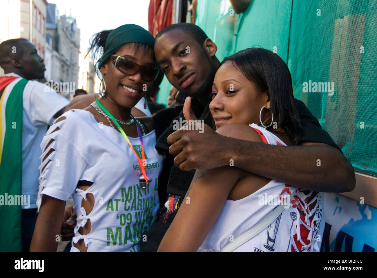 Close up of three people in the street posing mates Stock Photo - Alamy