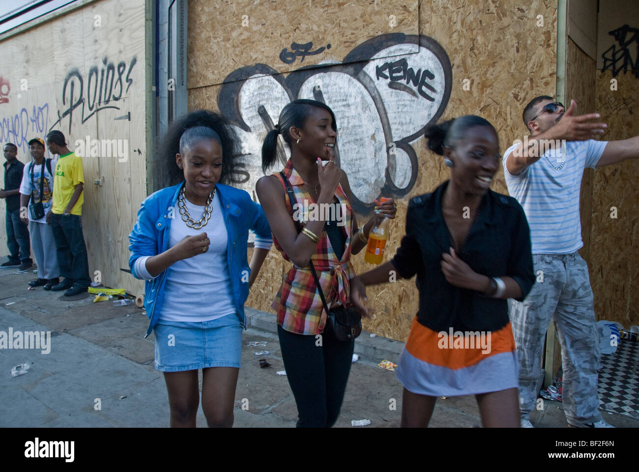 Youth messing around in street of boarded up shop fronts Stock Photo ...