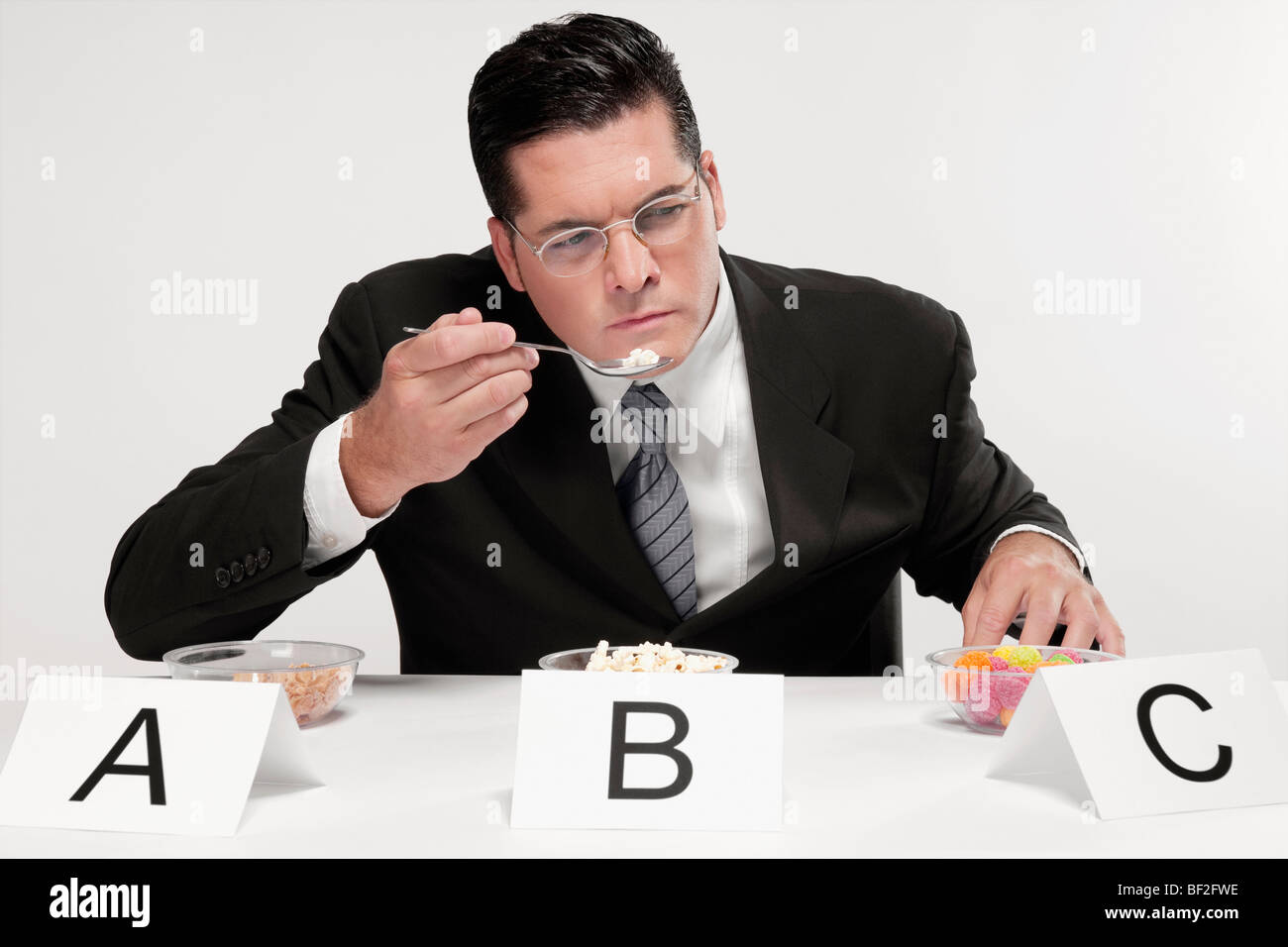 Businessman tasting food samples Stock Photo - Alamy