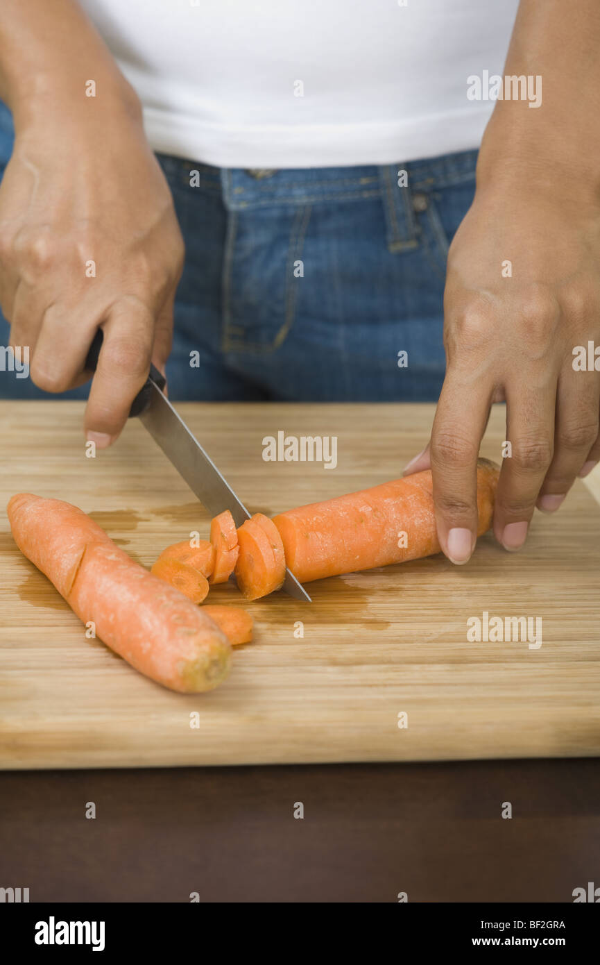 Mid section view of a woman cutting a carrot Stock Photo - Alamy