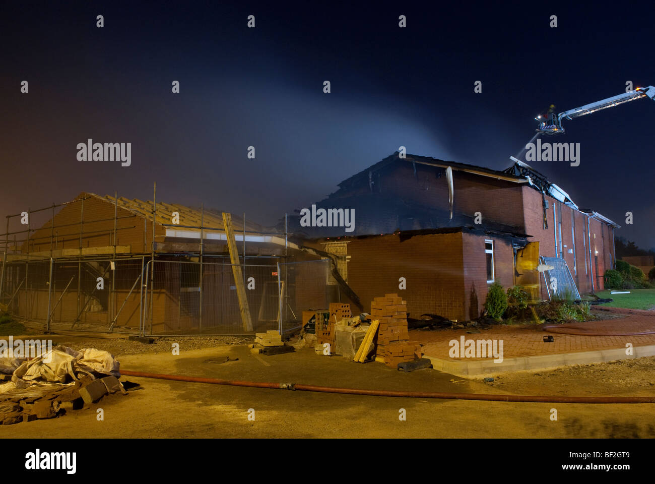 Community Centre under construction on fire at night Stock Photo - Alamy