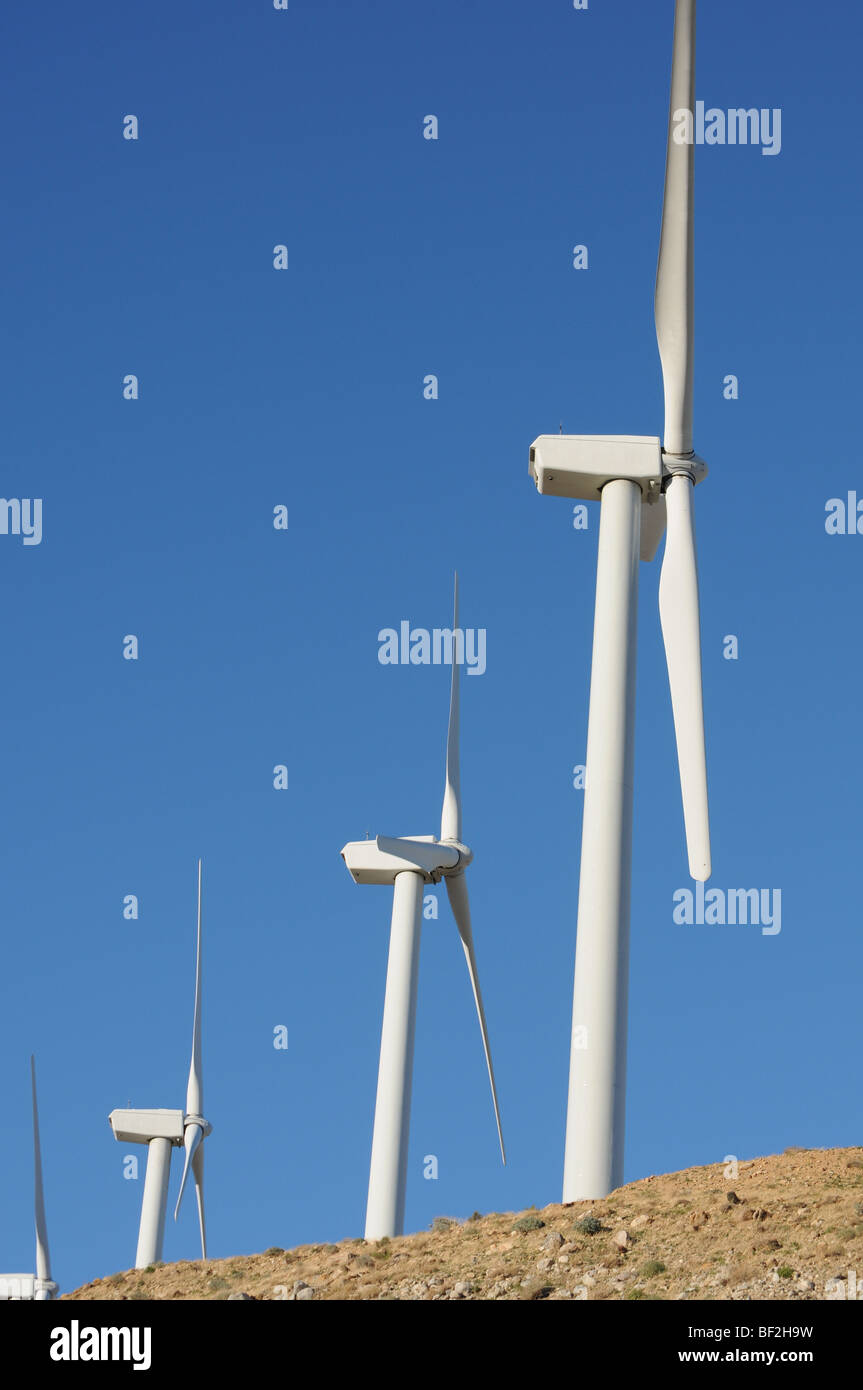 vertical row of wind turbines against a blue sky Stock Photo - Alamy