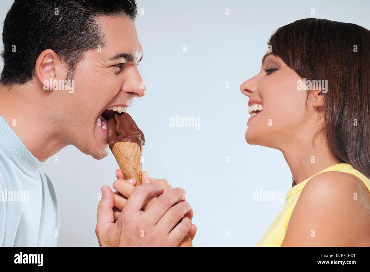 Woman feeding an ice cream cone to her husband Stock Photo - Alamy