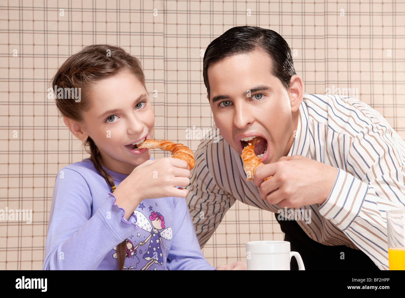 Man and his daughter eating breads Stock Photo - Alamy