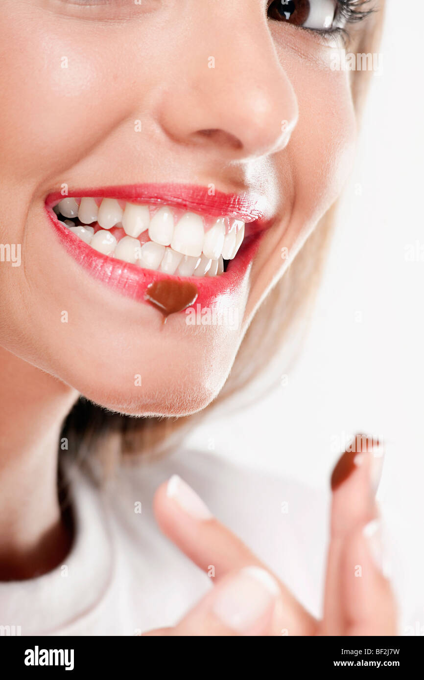 Chocolate drop on a woman's lip Stock Photo - Alamy