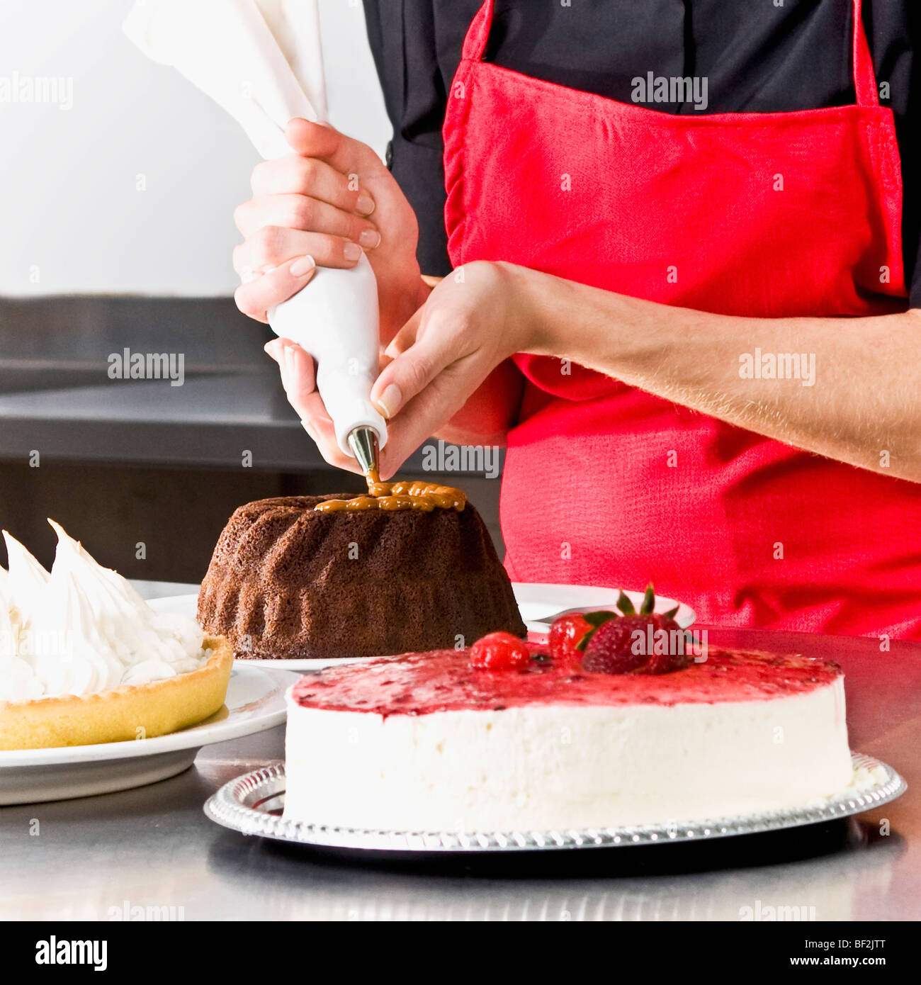 Mid section view of a female chef icing a cake Stock Photo - Alamy