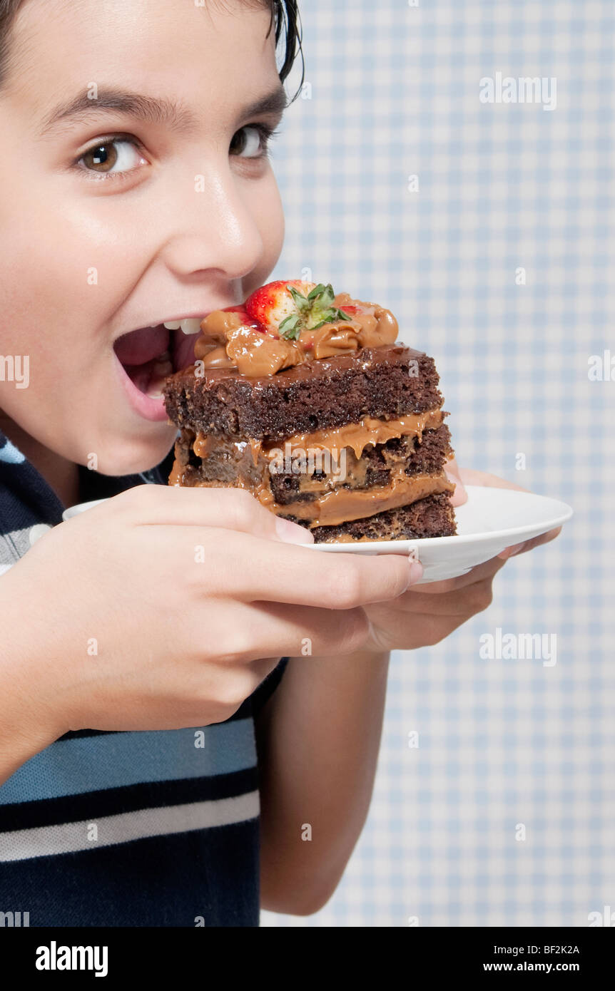 Boy eating a chocolate pastry Stock Photo - Alamy