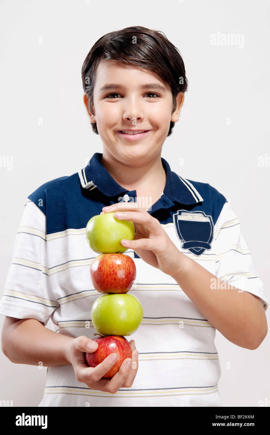 Portrait of a boy holding apples Stock Photo - Alamy