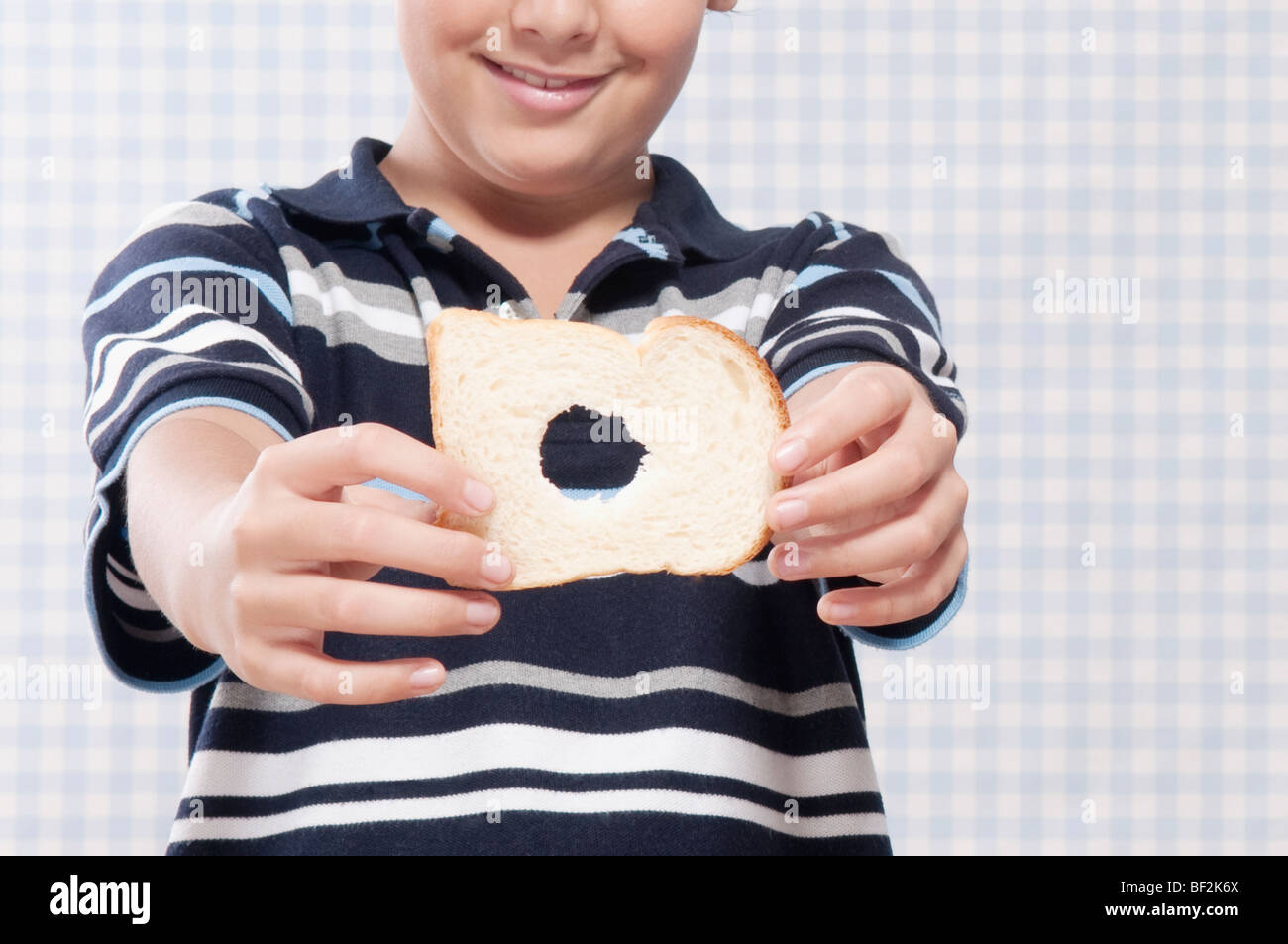 Boy holding a slice of bread Stock Photo - Alamy