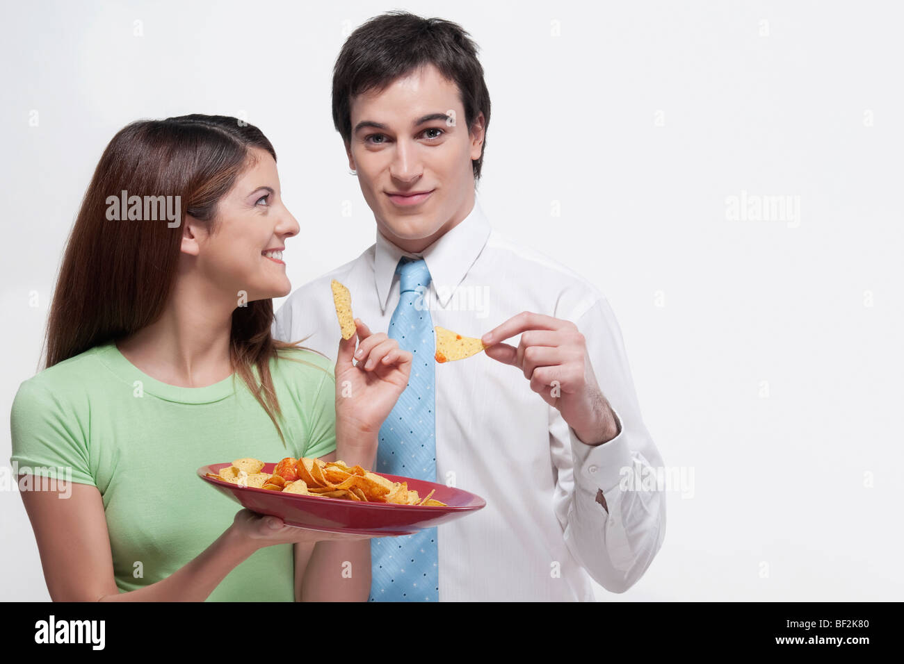 Couple eating nachos Stock Photo - Alamy