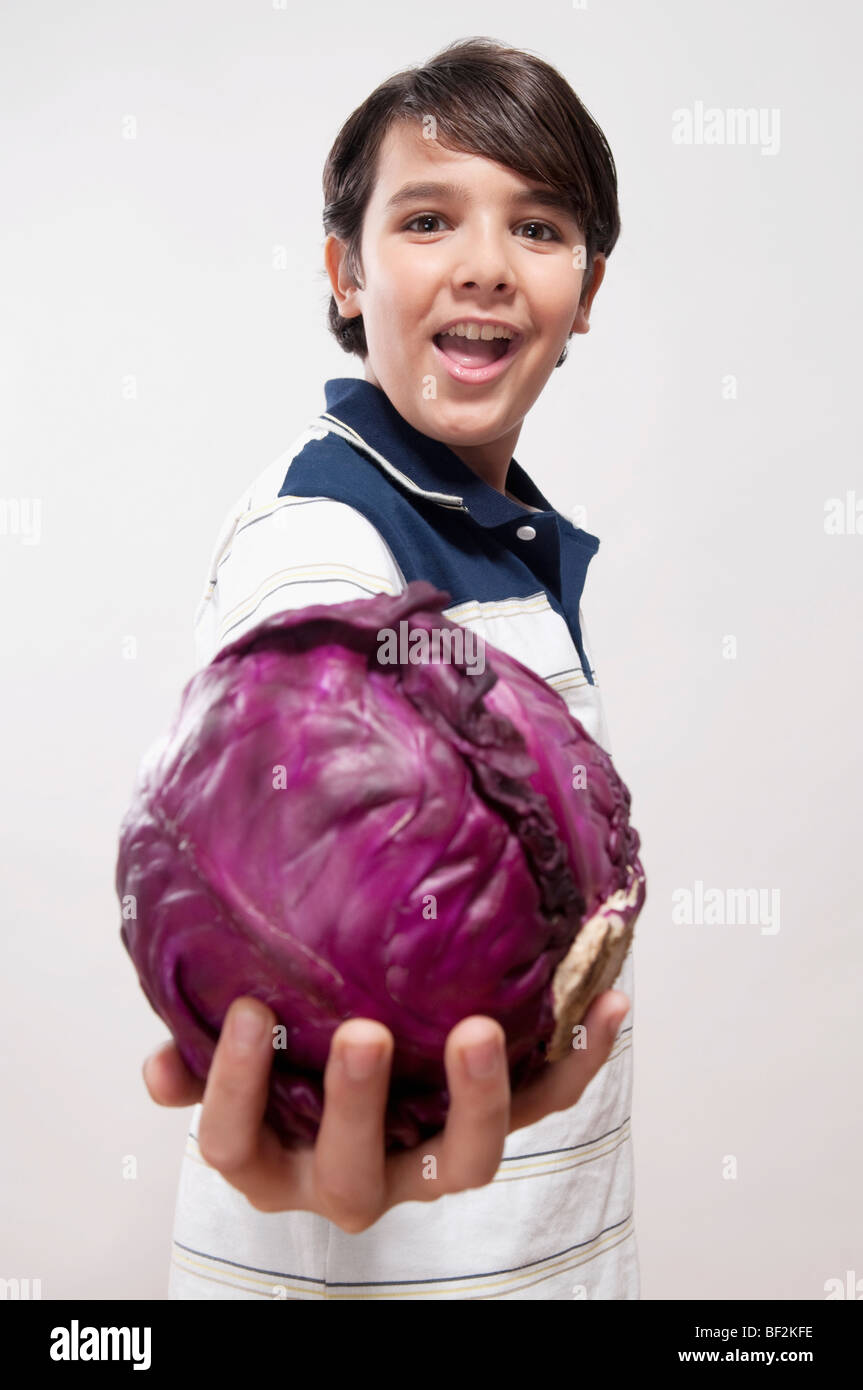 Portrait of a boy showing a red cabbage Stock Photo - Alamy