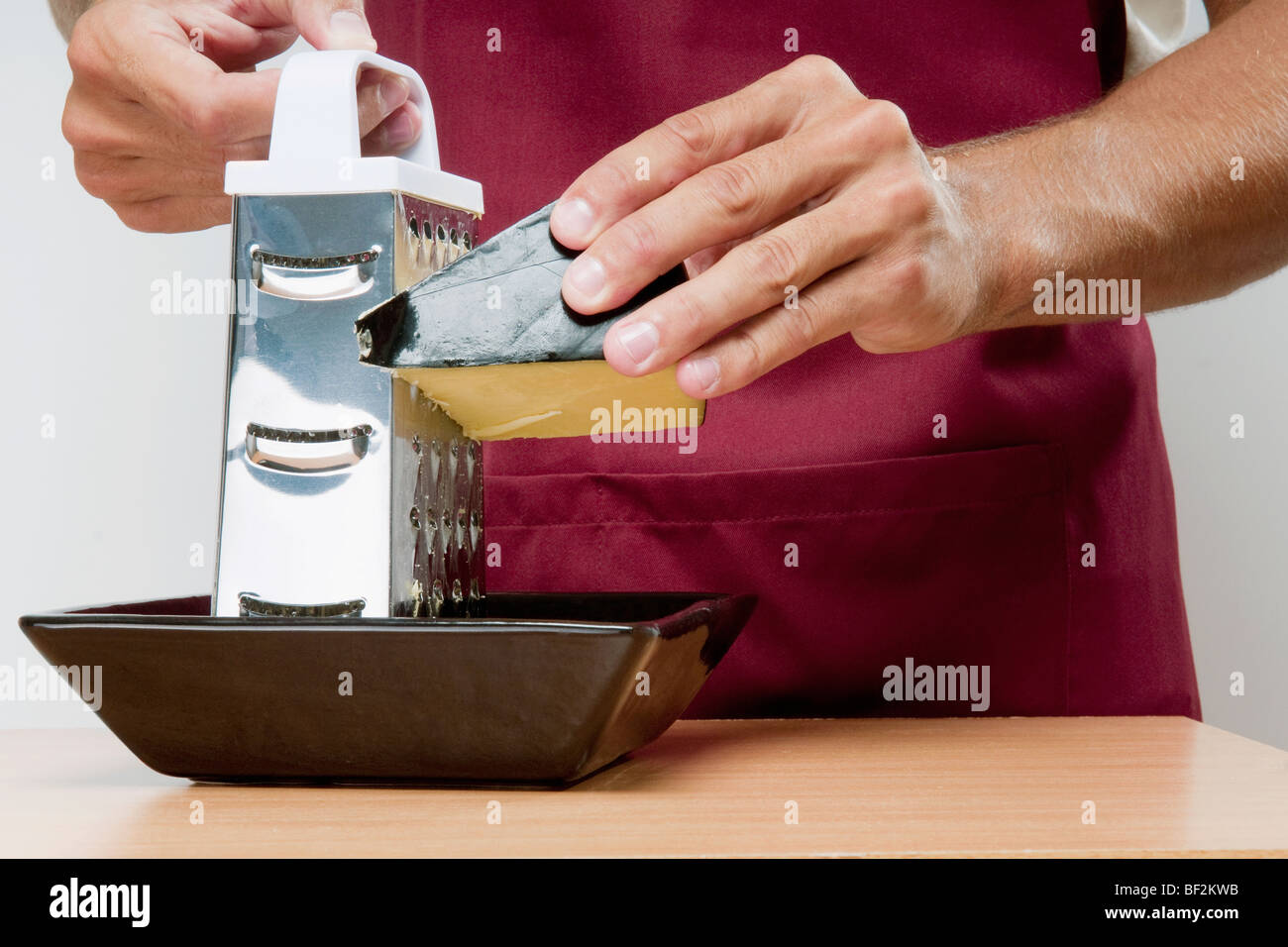 Mid section view of a man grating cheese Stock Photo - Alamy