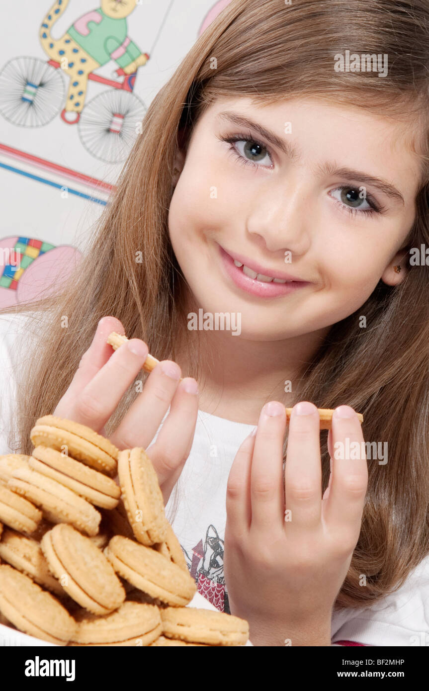 Girl eating cookies Stock Photo - Alamy