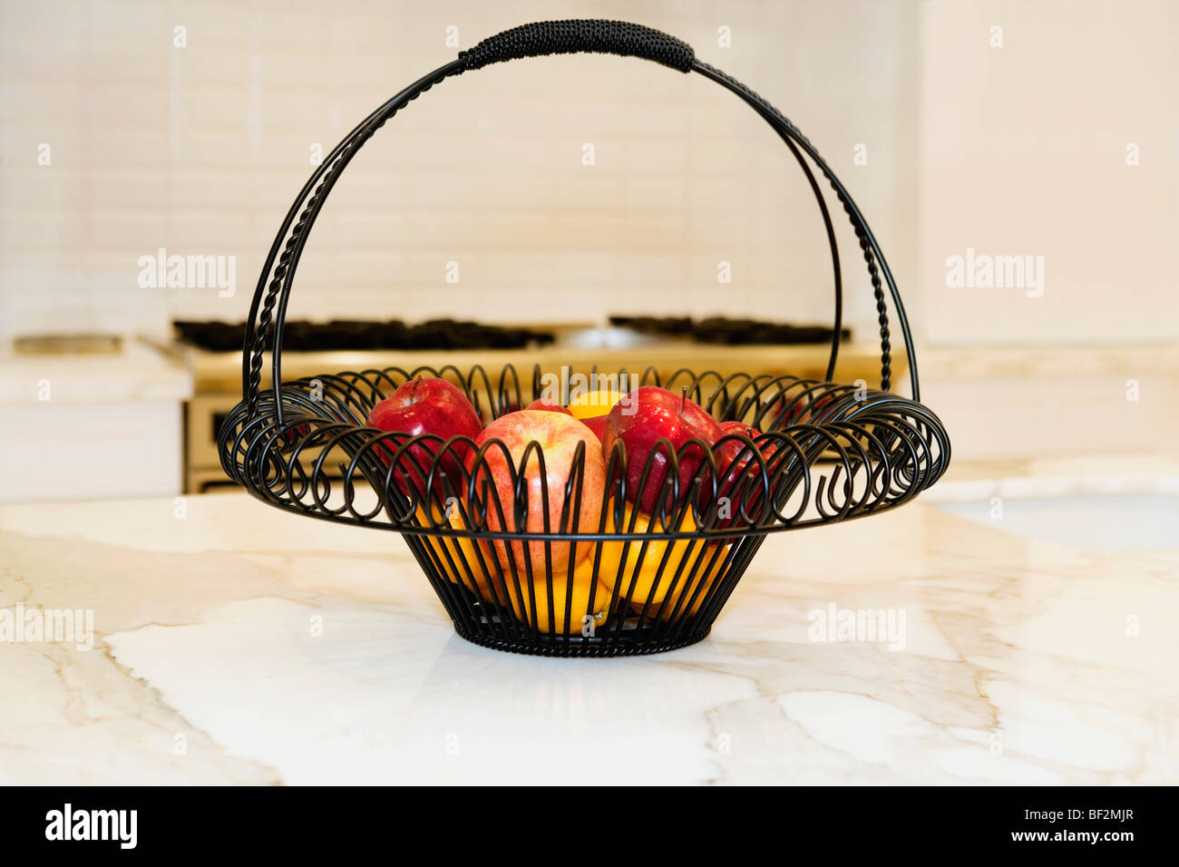 Fruits in a basket on a kitchen counter Stock Photo - Alamy