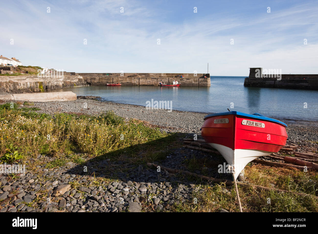 Craster, Northumberland, England, UK. Red boat on shore by harbour in ...