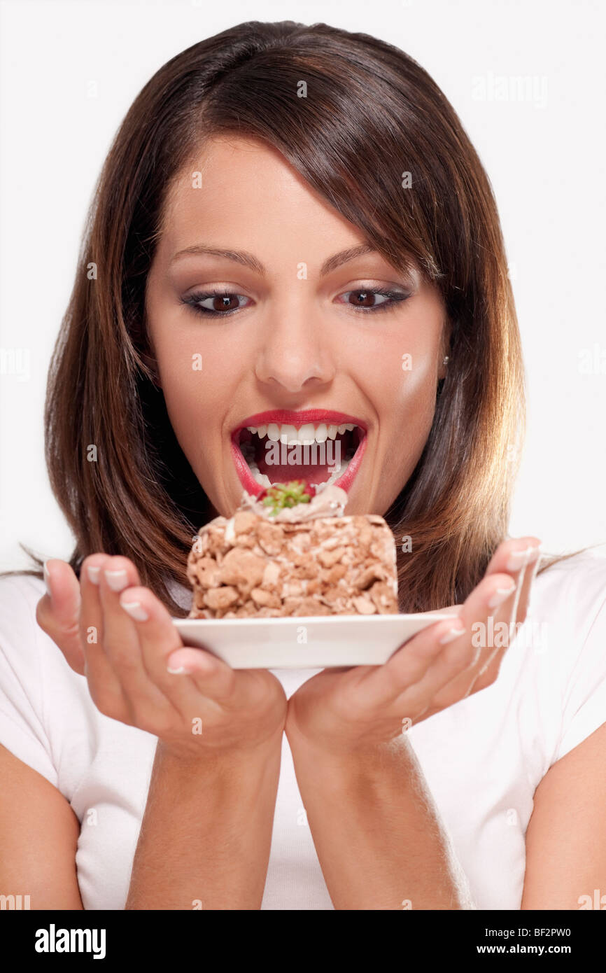 Woman holding a pastry on a plate Stock Photo - Alamy