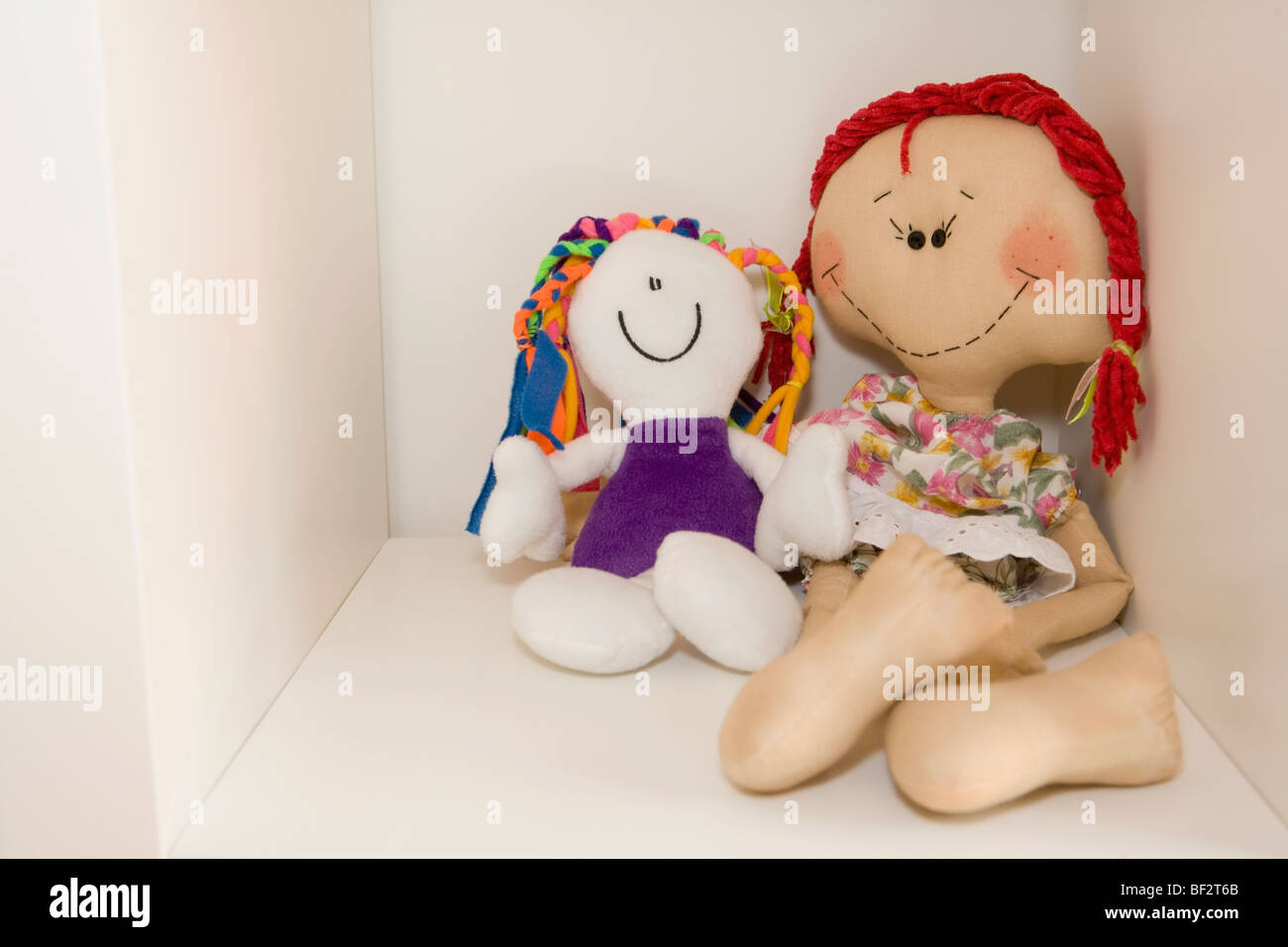Two dolls on a shelf Stock Photo - Alamy