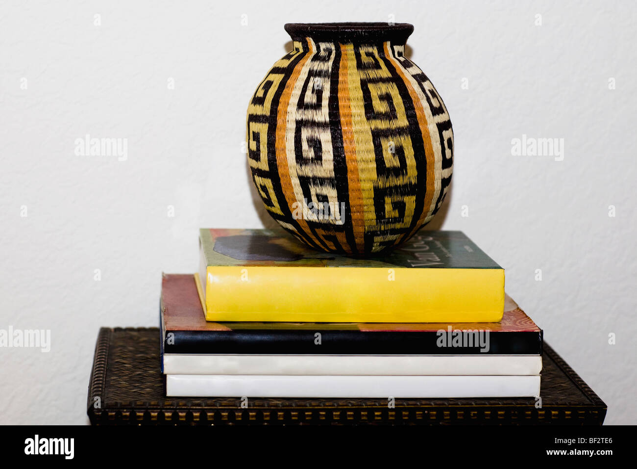 Pot on a stack of books Stock Photo - Alamy