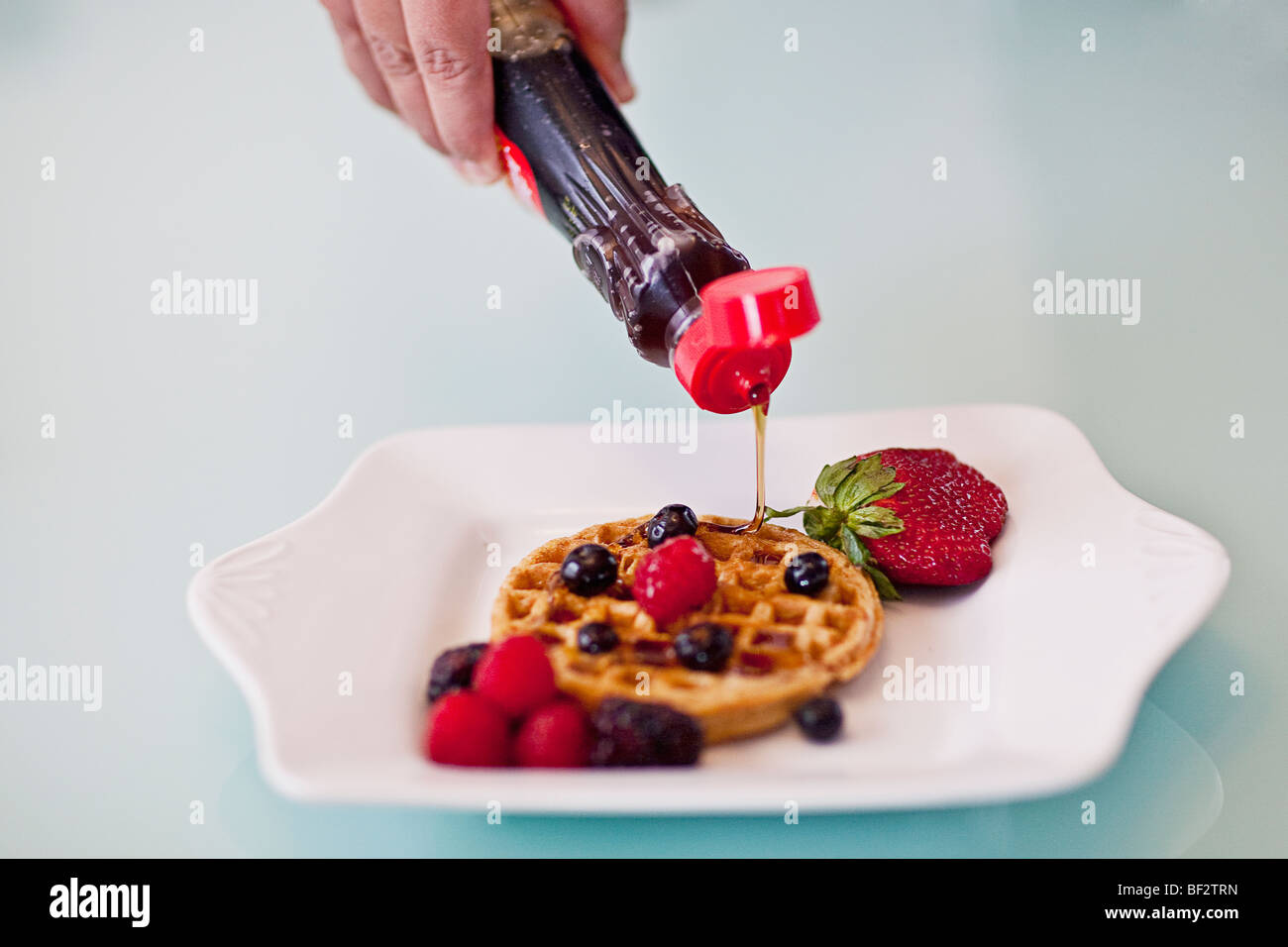 Close up hand pouring strawberry hi-res stock photography and images ...
