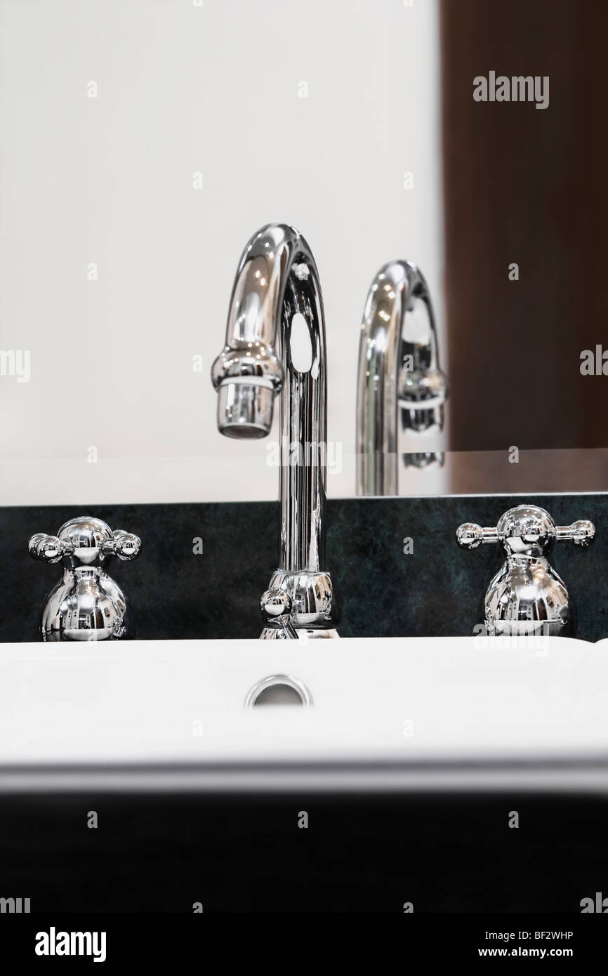 Faucet near a bathroom mirror Stock Photo - Alamy