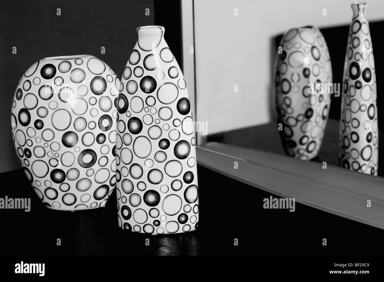 Reflection of two vases in a mirror Stock Photo - Alamy