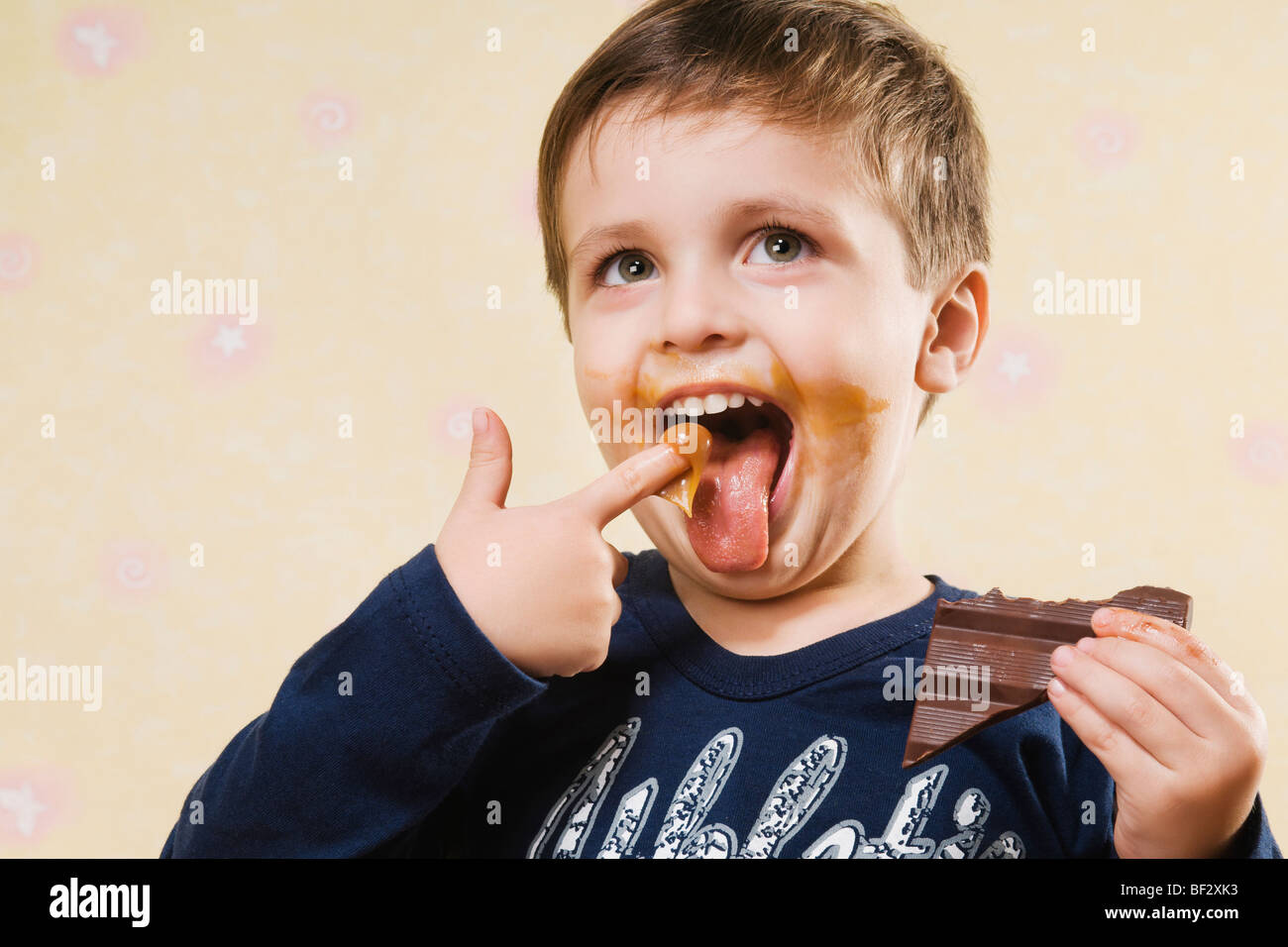 Boy eating a chocolate Stock Photo - Alamy