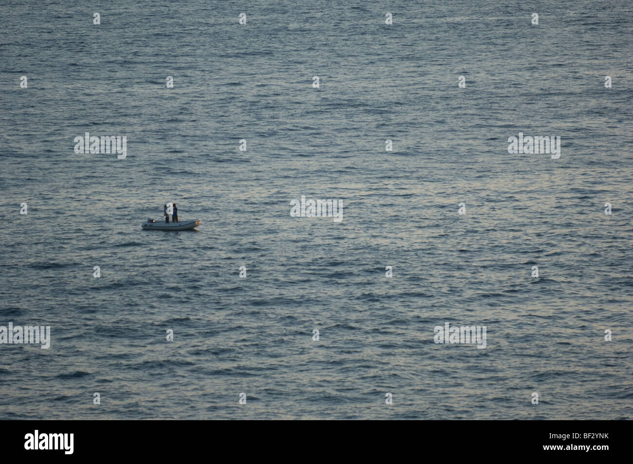 Big ocean, tiny boat. Two people go fishing in the Pacific ocean using ...