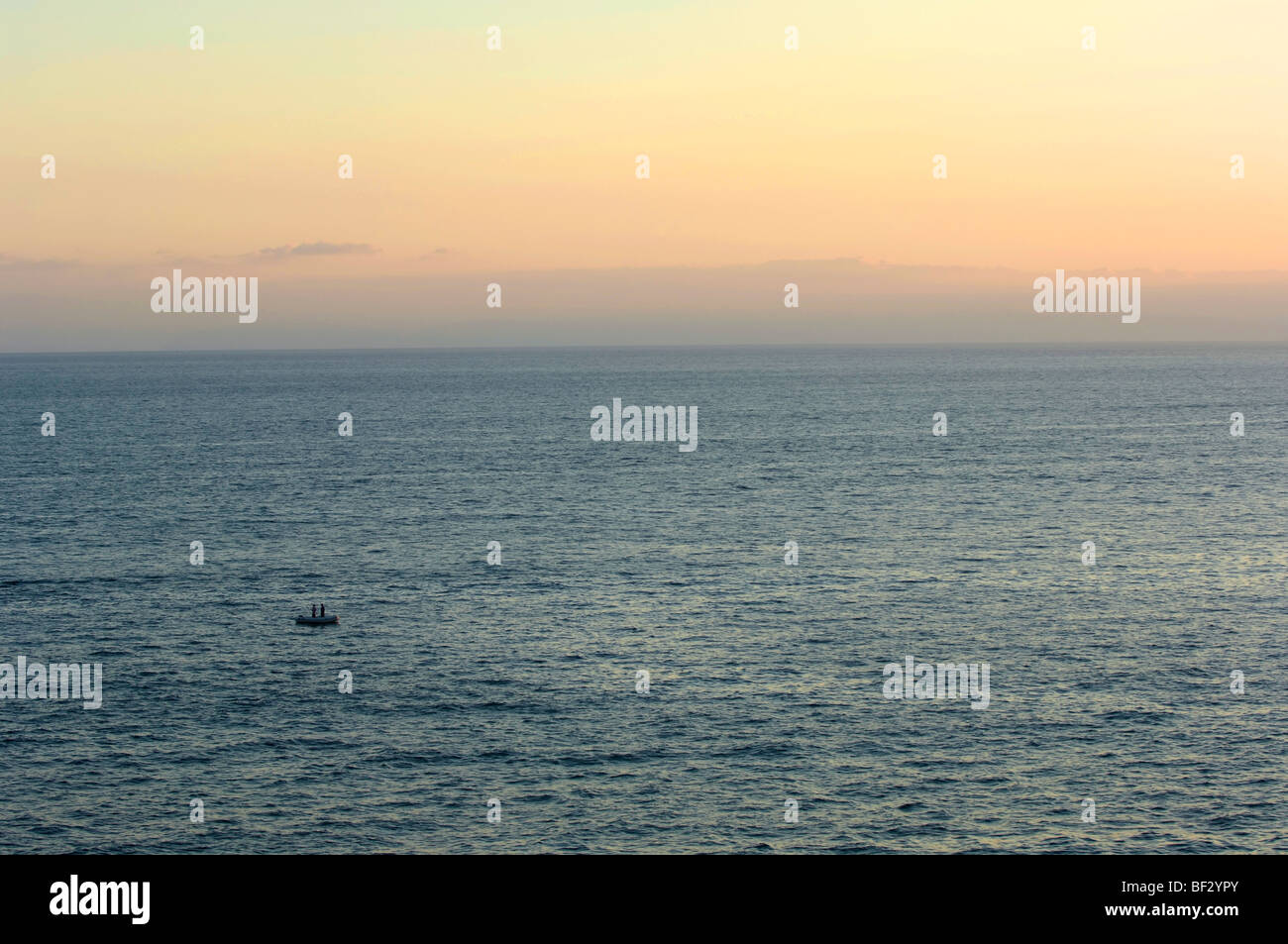 Big ocean, tiny boat. Two people go fishing in the Pacific ocean using ...